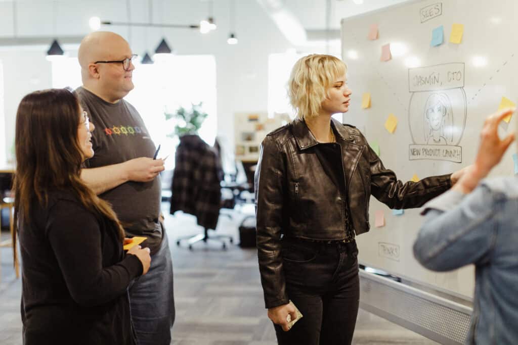 Pictured is author Rebecca Rayford at a whiteboard with co-workers. Post title: Use React Hook Forms with Zod Validation, Part Two: Using FormProvider