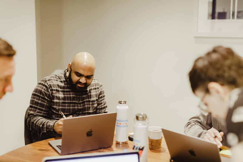 Author Pavan Policherla with his software development team. Post title: Skills I developed as a Junior dev that I still use today