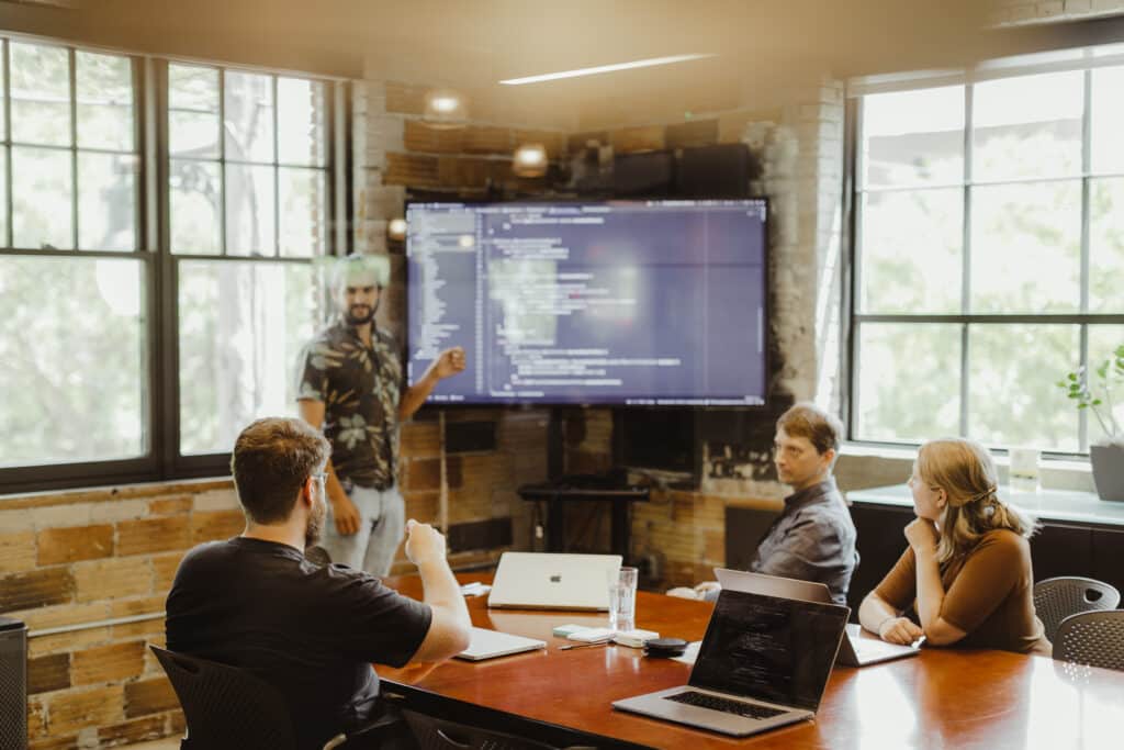 Part of the Atomic Grand Rapids team sit around a table together. Post title: Automatically Log In to an Ubuntu Head